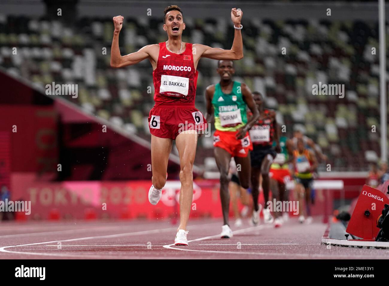 Soufiane El Bakkali, of Morocco, celebrates as he crosses the finish ...