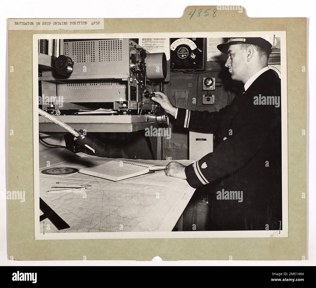 A Coast Guard navigator aboard ship uses a LORAN receiver to obtain ...