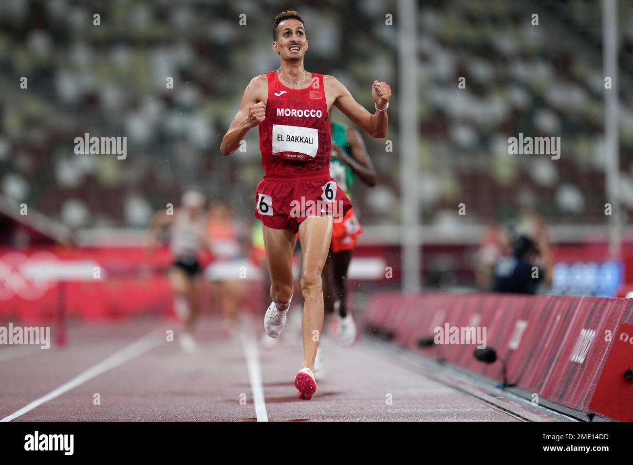 Soufiane El Bakkali, of Morocco, reacts as he crosses the finish line ...