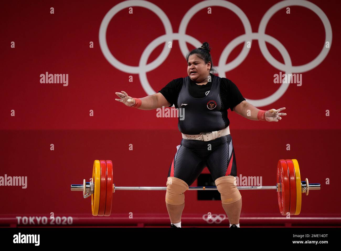 Nurul Akmal of Indonesia drops the barbell during a lift, in the women ...