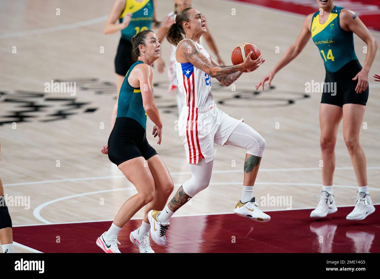 Puerto Rico's Jazmon Gwathmey (24) drives to the basket past Australia ...