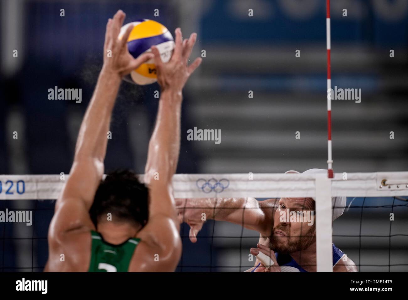 Brazil's Alison Cerutti (1) takes a shot as Mexico's Jose Luis Rubio ...