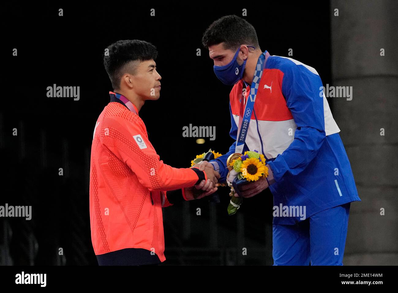 Japan's Kenichiro Fumita, left, congratulates Cuba's Luis Orta Sanchez ...