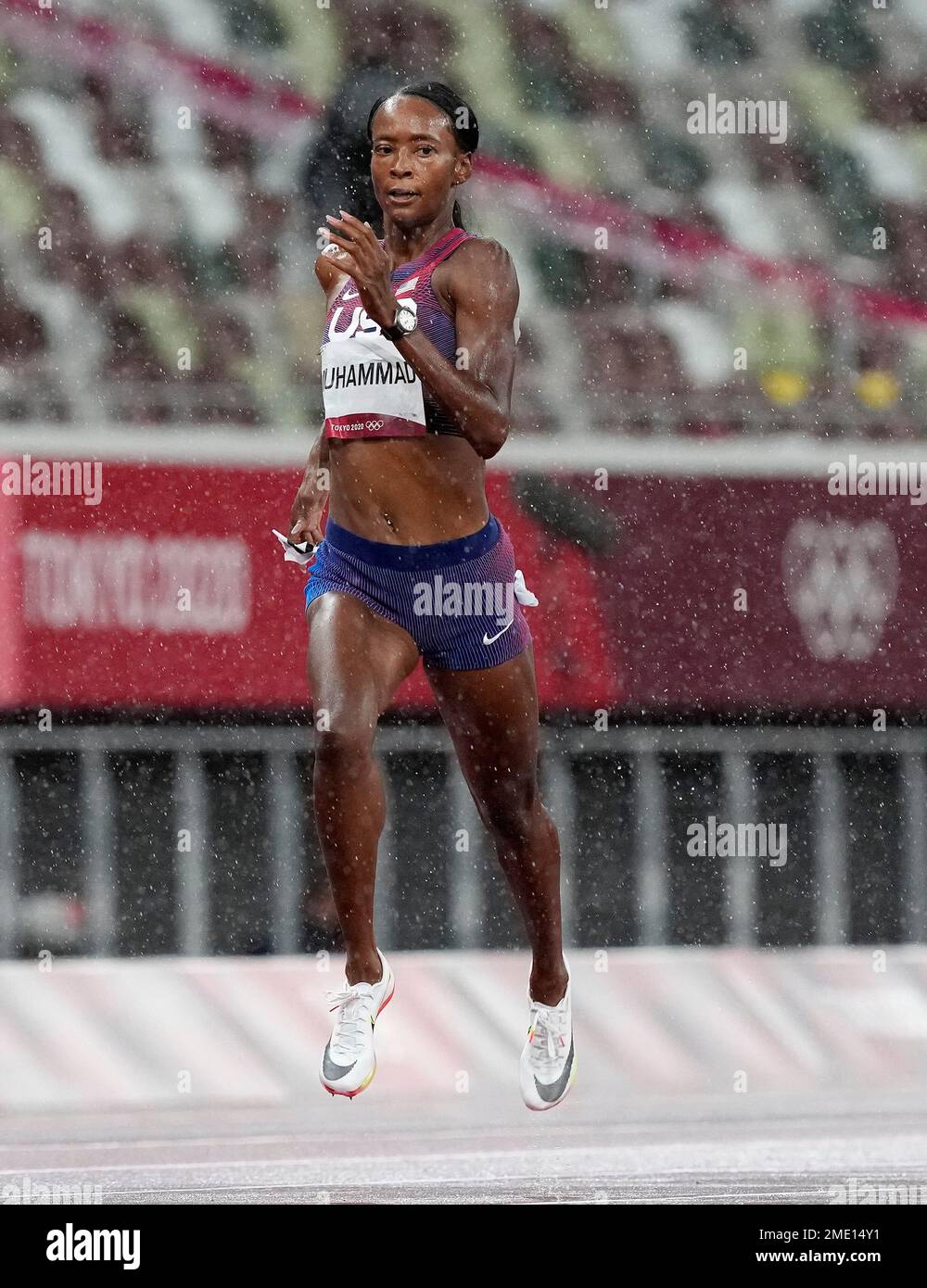 Dalilah Muhammad, of United States races to win a heat of the women's ...