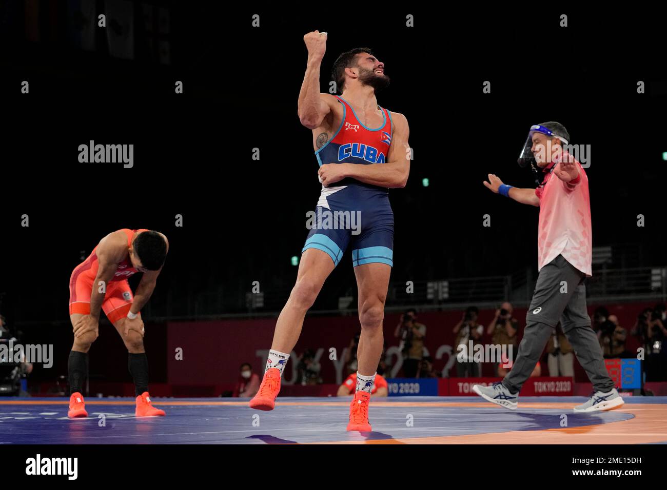 Cuba's Luis Orta Sanchez, center, celebrates defeating Japan's ...