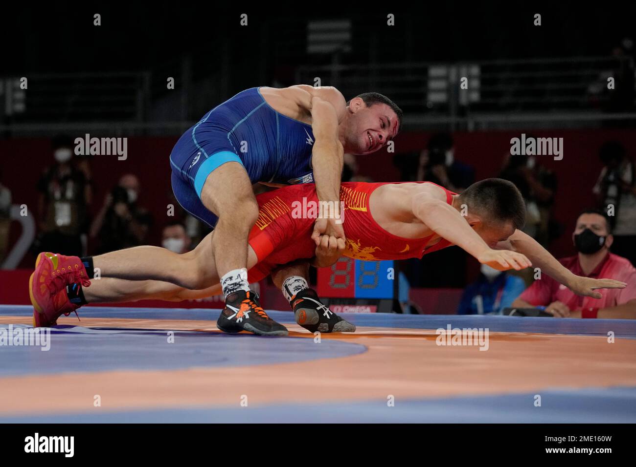 China's Sailike Walihan, bottom, and Ukraine's Lenur Temirov compete ...