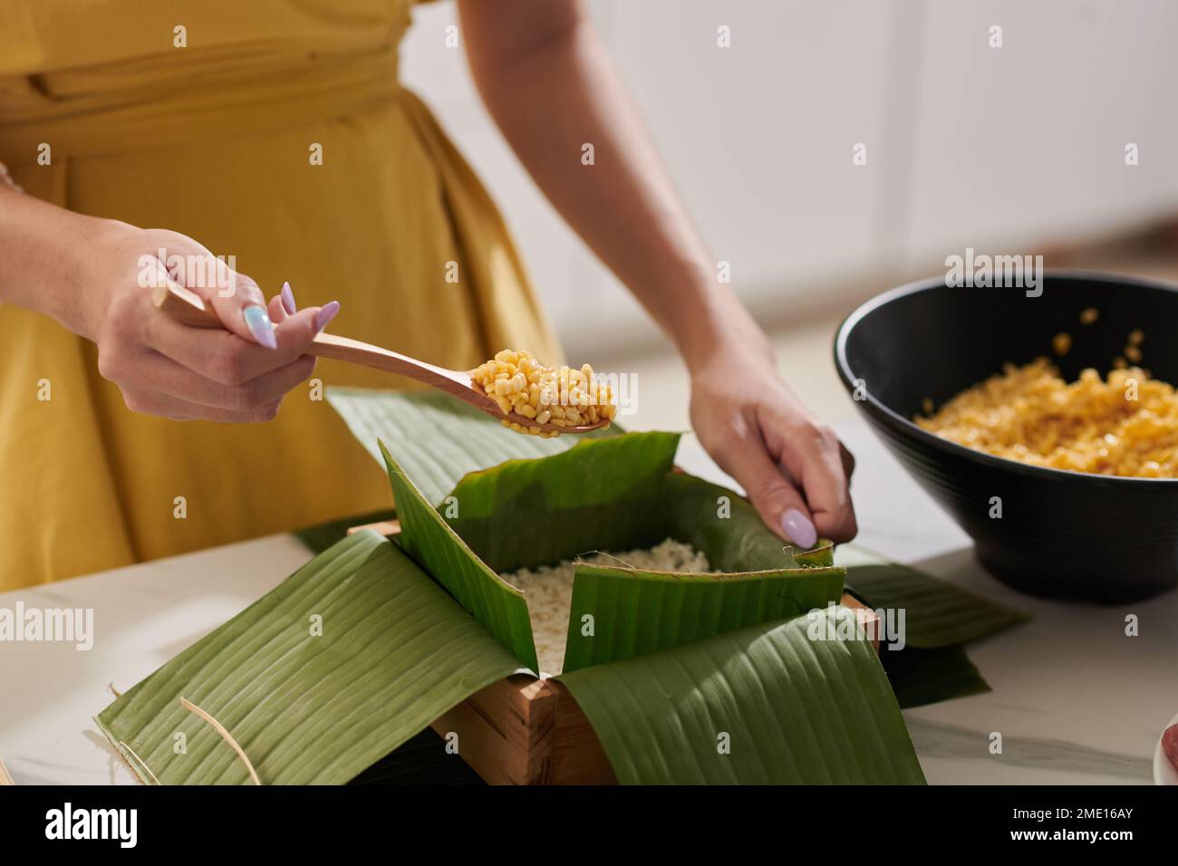Young female putting rice in hi-res stock photography and images - Alamy