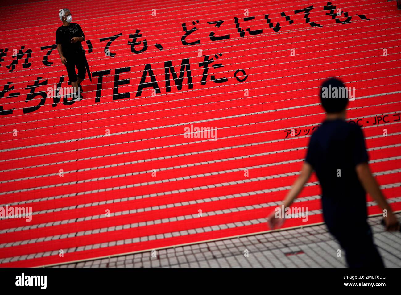A pedestrian walks down a stairwell outside an office building ...