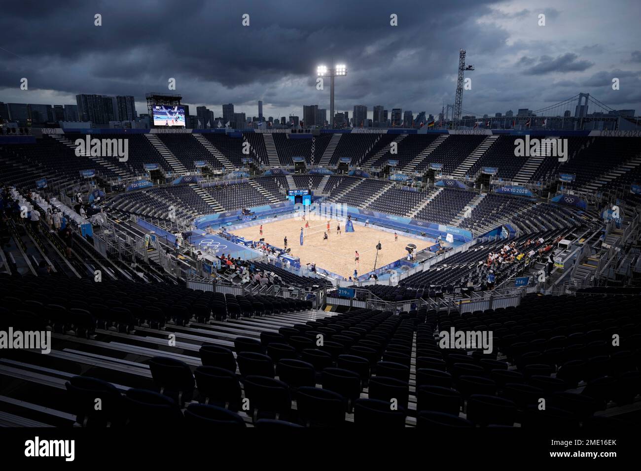 The Spanish beach volleyball team, front, takes on the team of the ...