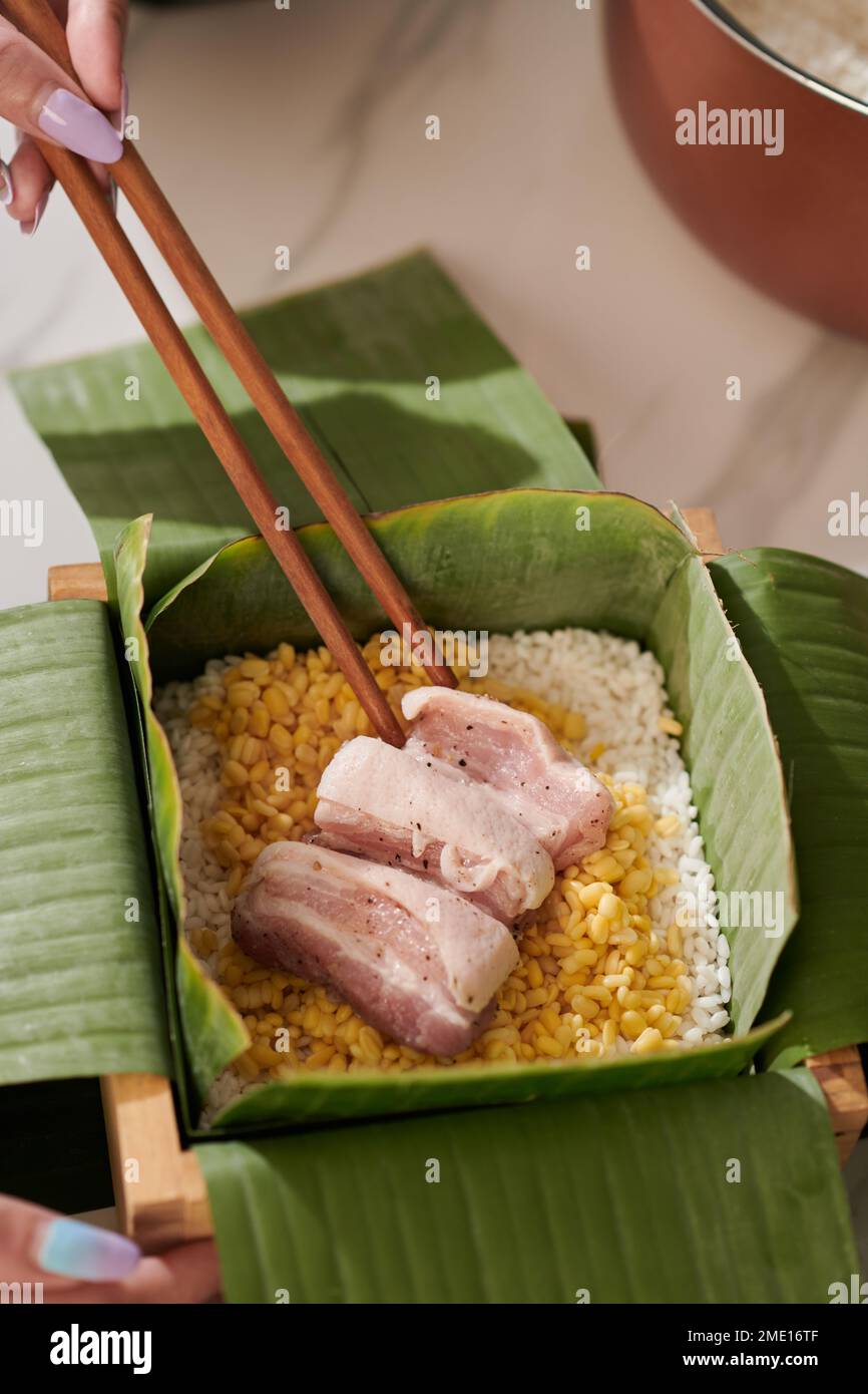 Pieces of marinated pork inside sticky rice cake cooked for Tet Stock ...
