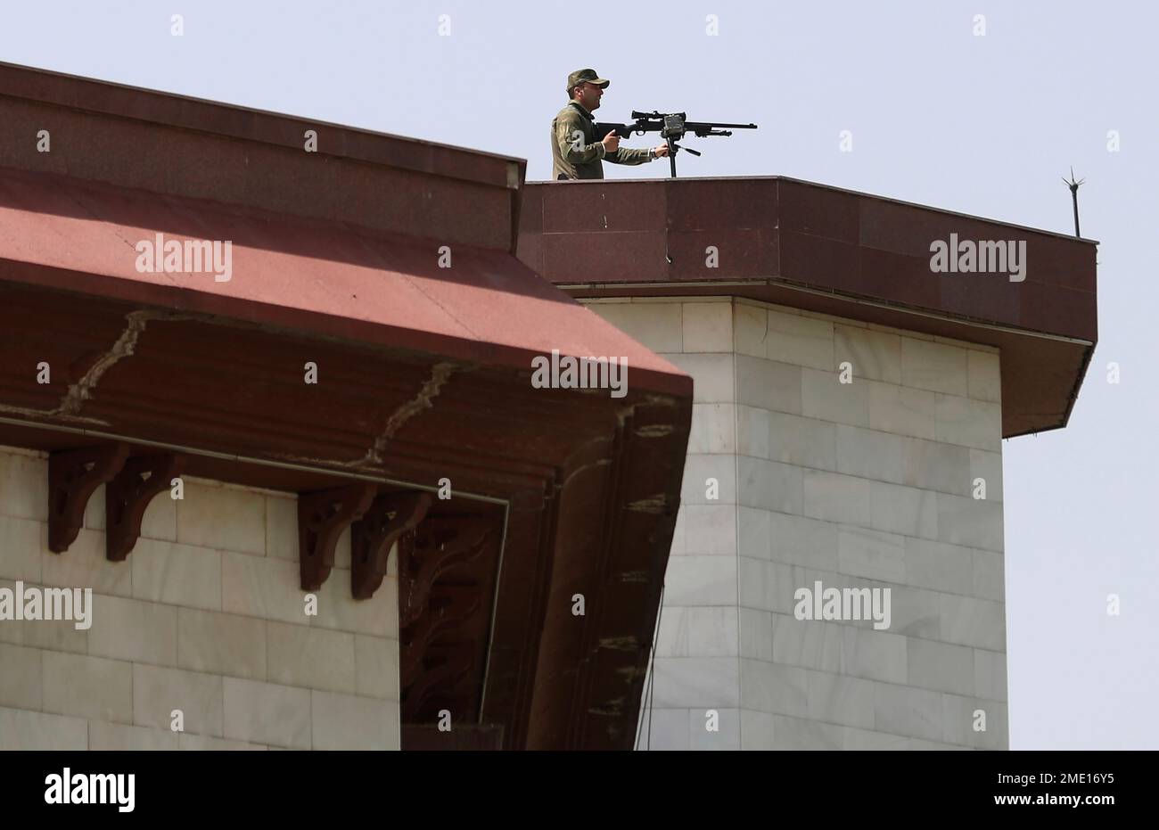 Rooftop security stands guard on the top of a Parliament building as ...