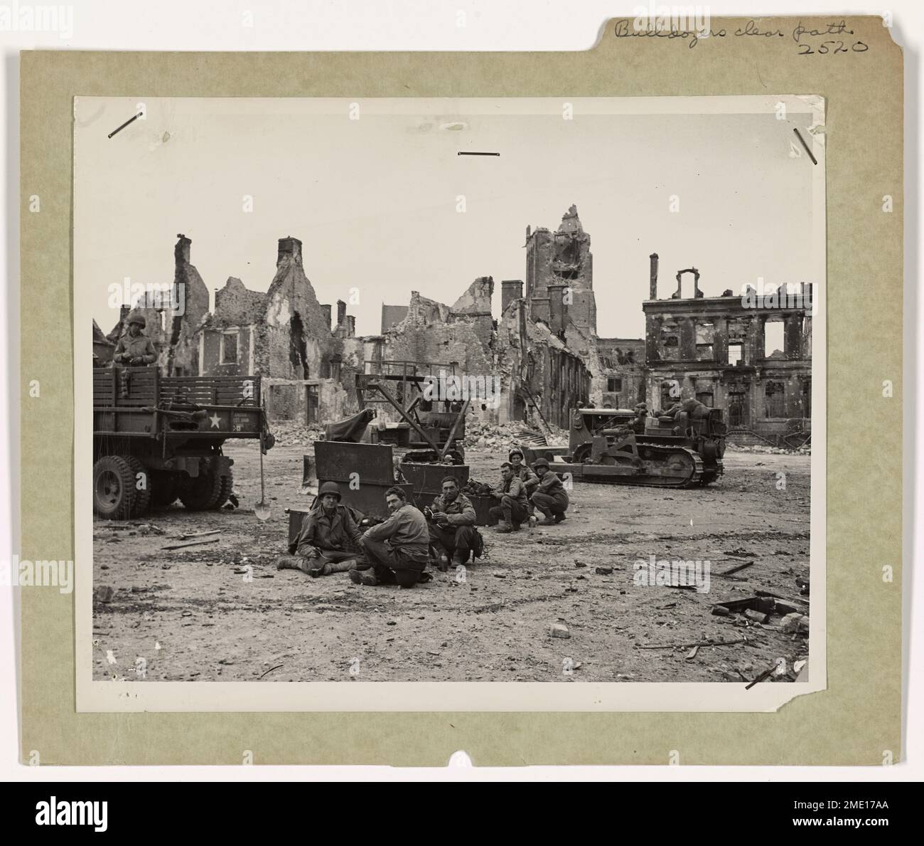 This photograph shows Army bulldozers clearing debris in Montebourg ...