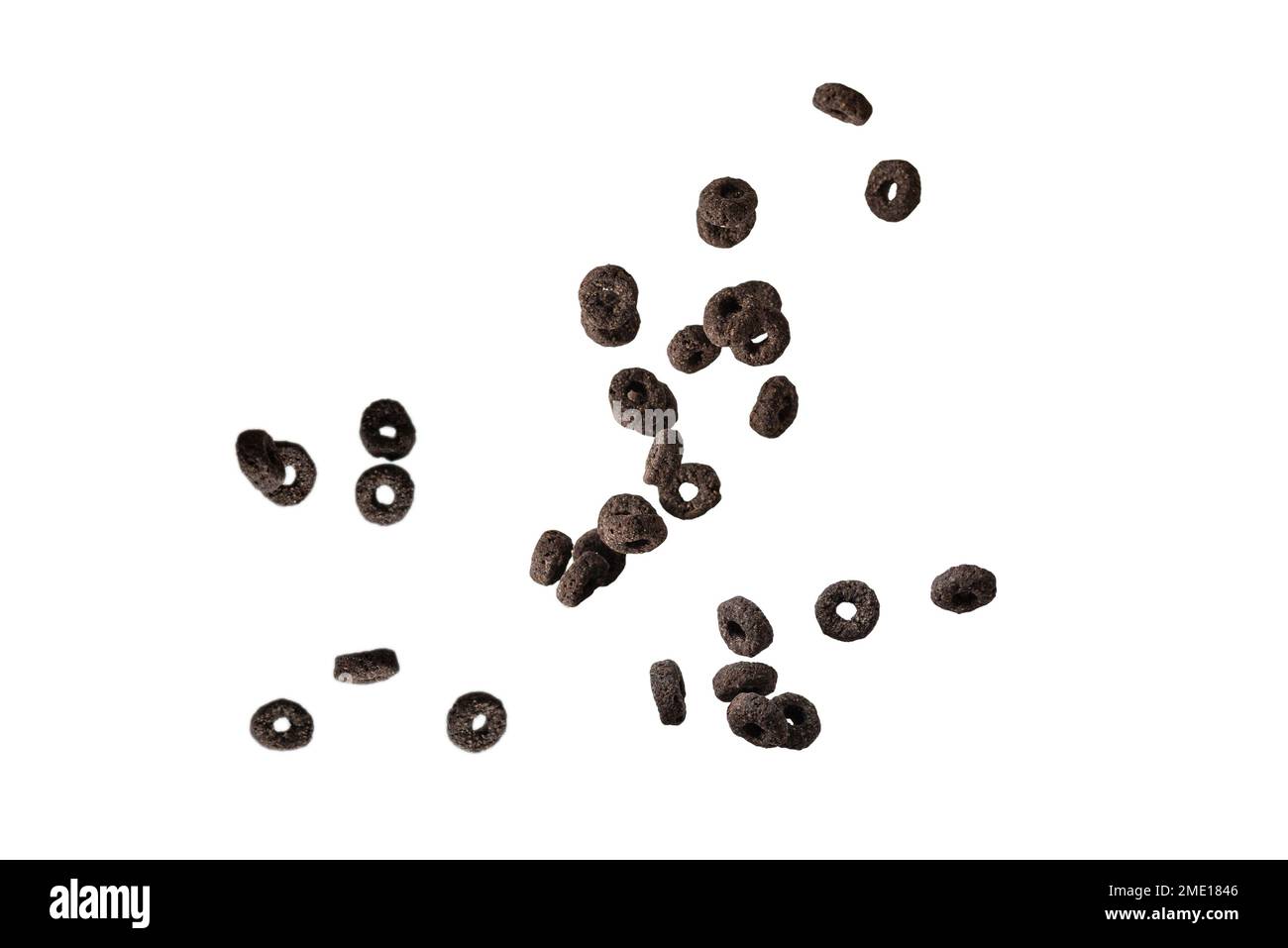 Chocolate rings cereal spill out into a bowl. Breakfast. Isolated on a ...