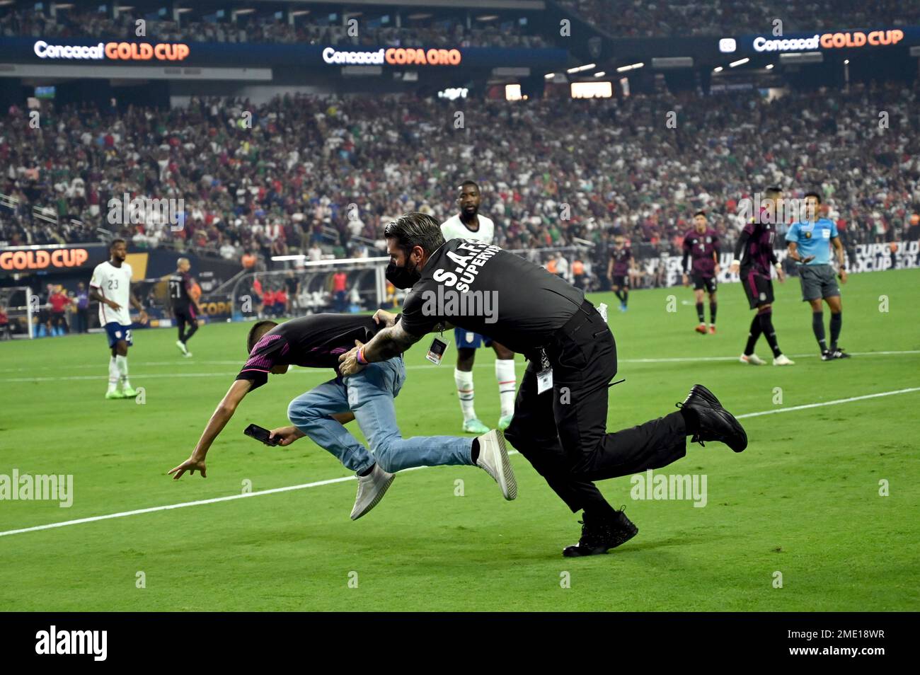 A security guard tackles a spectator who ran on the field during the ...