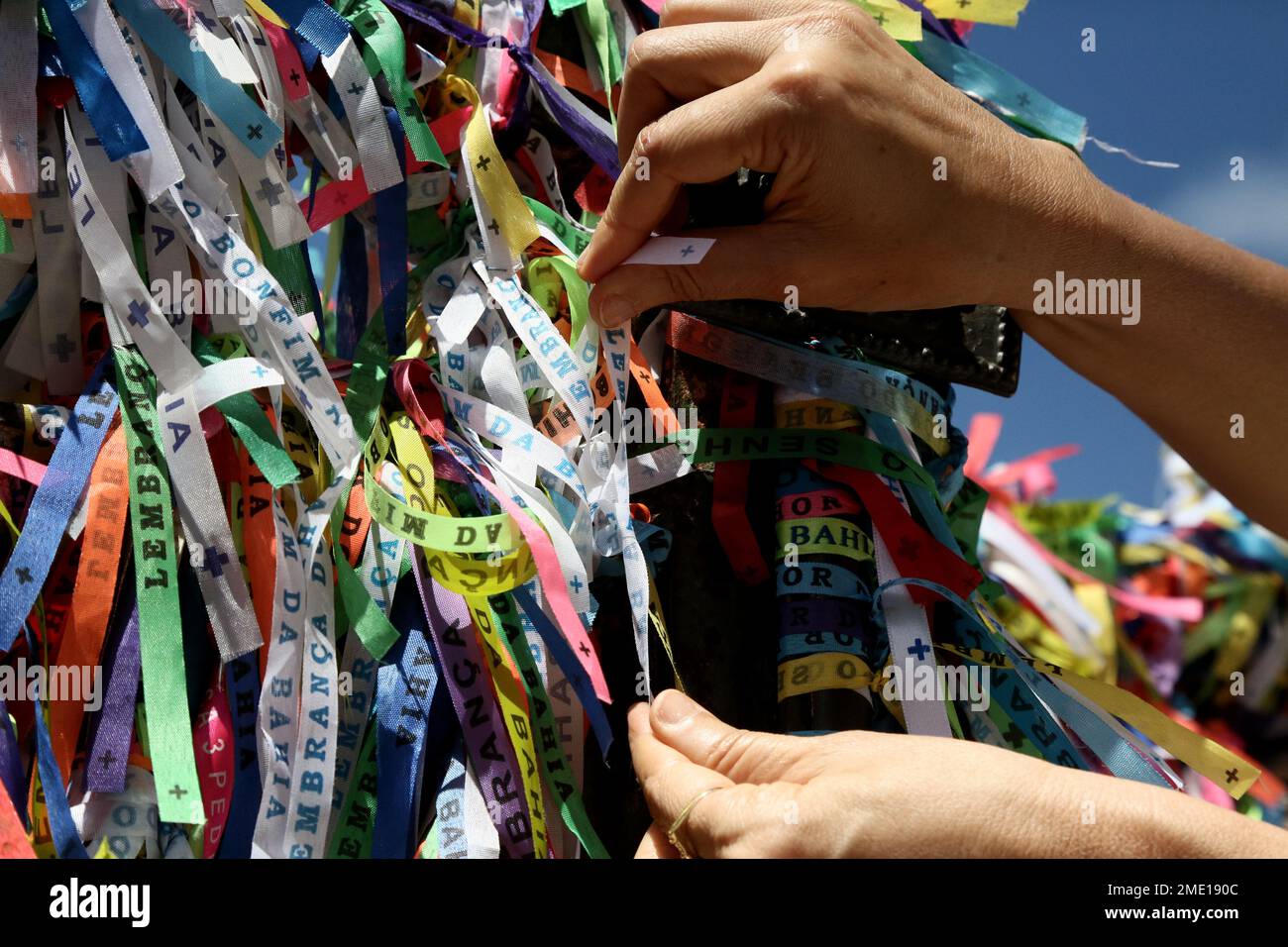 salvador, bahia, brazil - january 15, 2023: devotees tie ribbons during ...