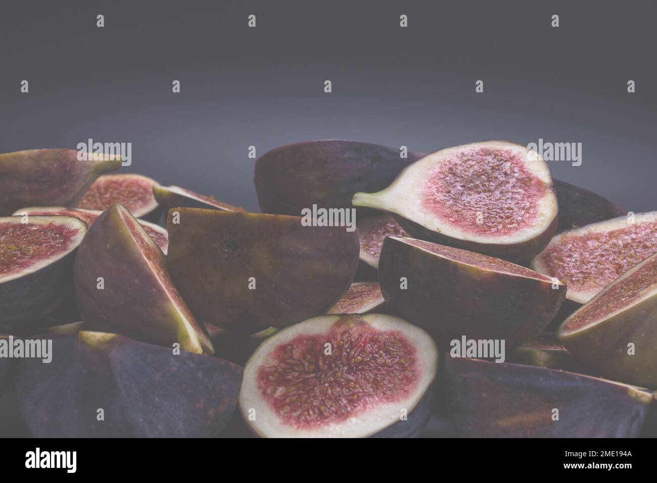 Tasty figs on a black background. Top view. Slices Stock Photo - Alamy