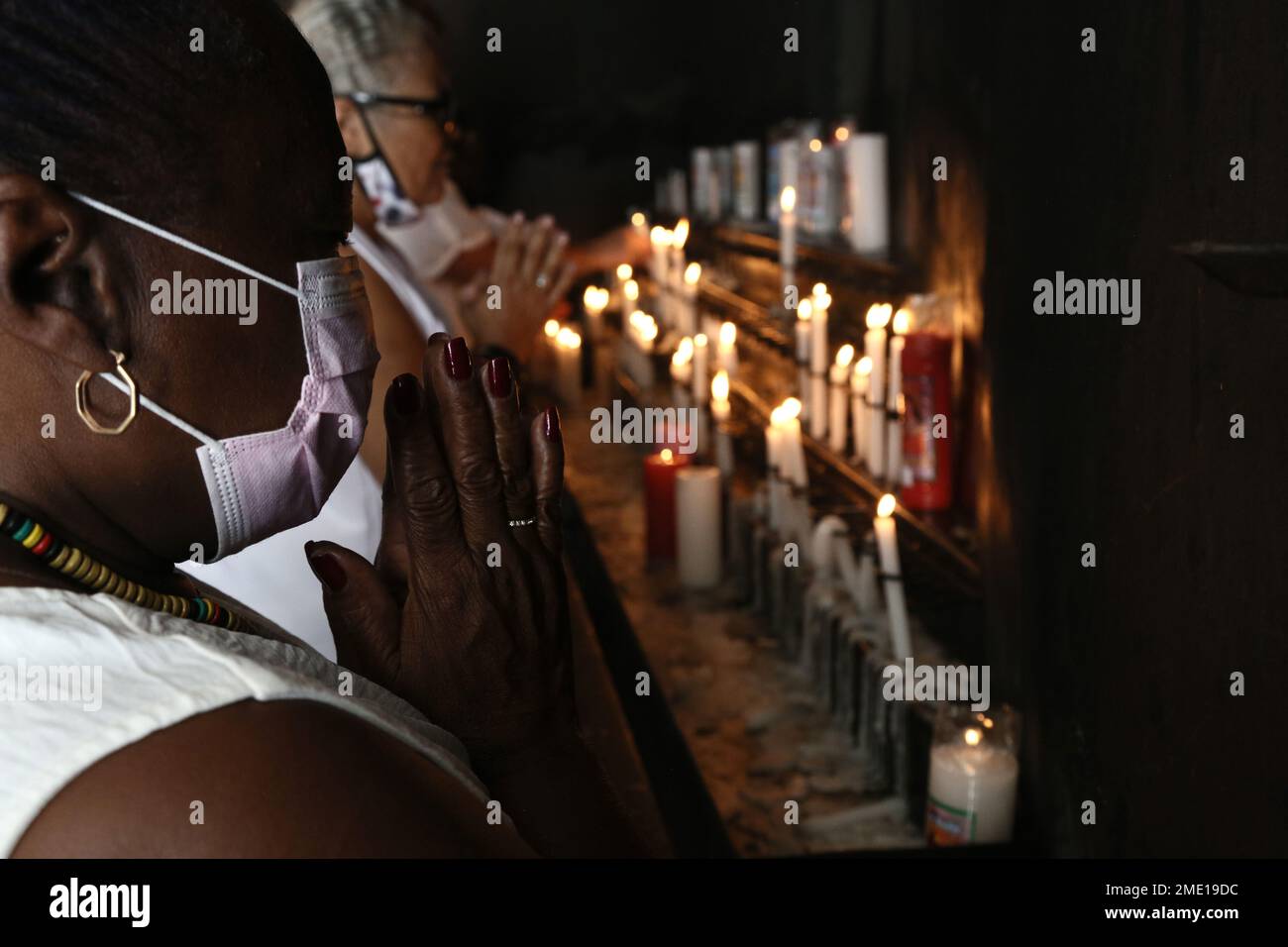 salvador, bahia, brazil - january 15, 2023: devotees light a candle ...
