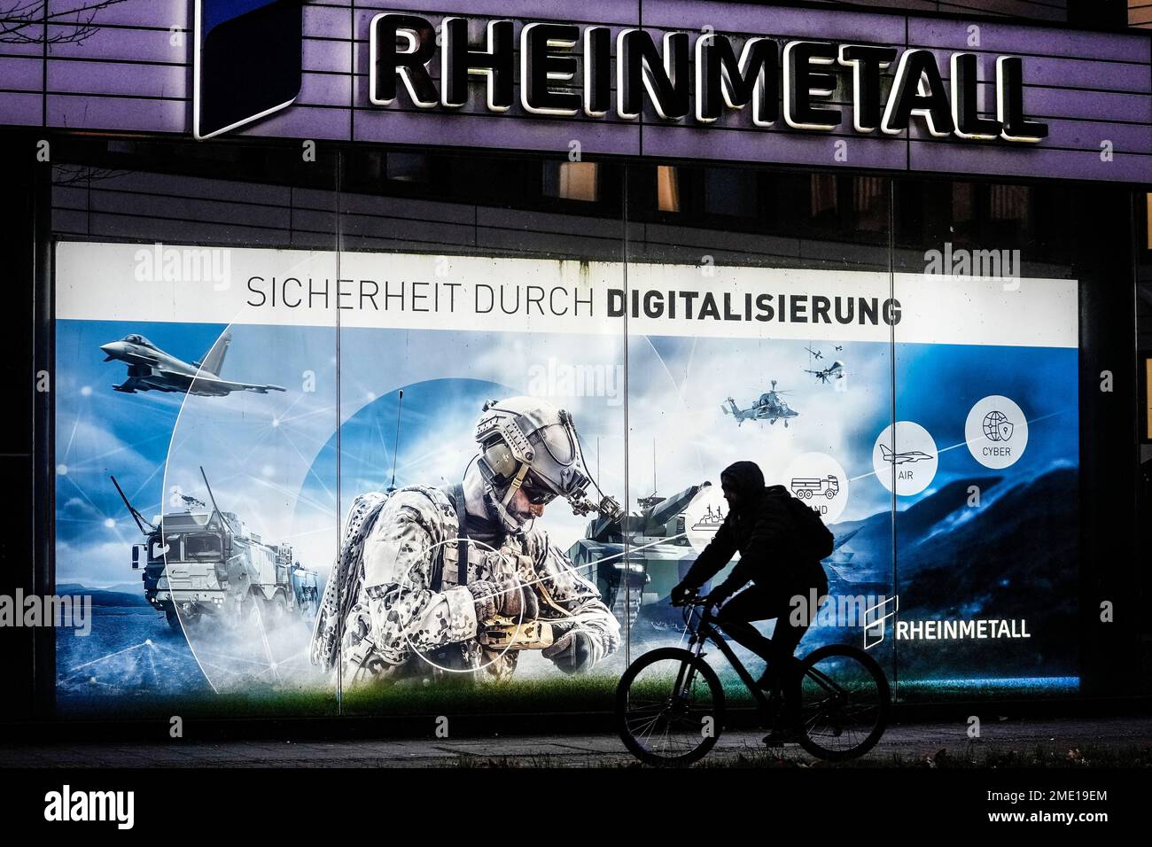 A man on a bicycle passes the headquarters of Germany's biggest arms ...