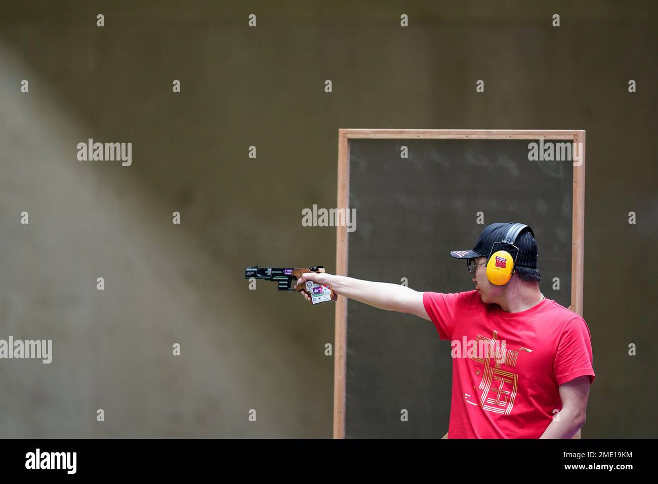 Li Yuehong, of China, competes in the men's 25-meter rapid fire pistol ...
