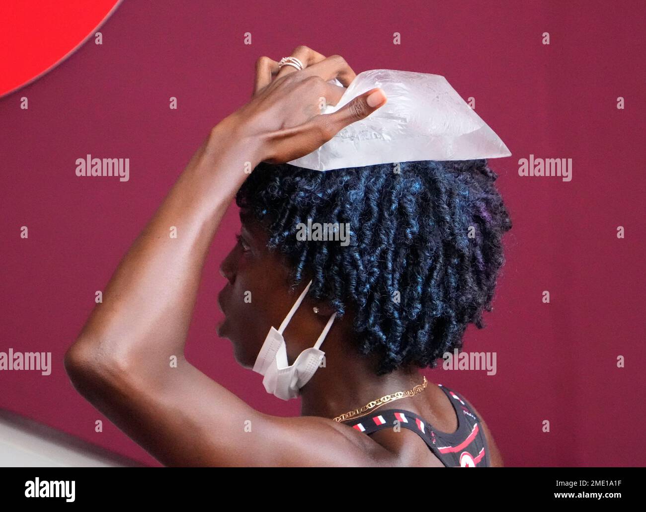 Crystal Emmanuel, of Canada leaves the track with an ice pack on her ...