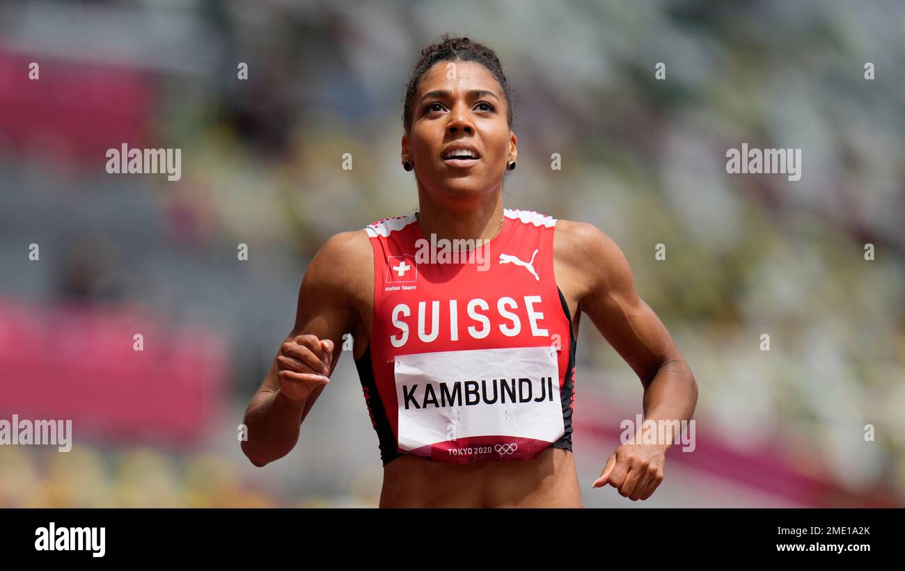 Mujinga Kambundji, of Switzerland, crosses the finish line in her heat ...