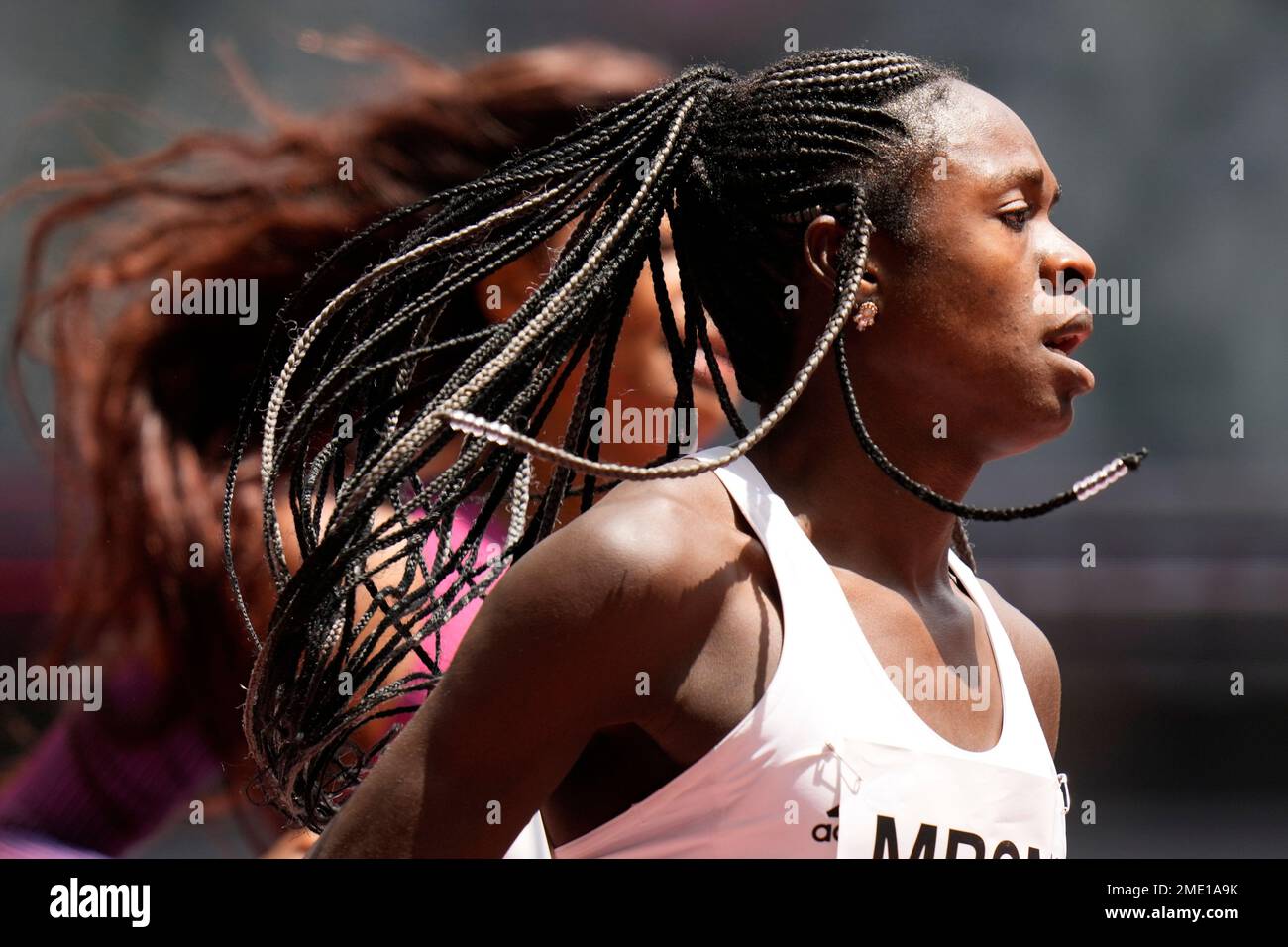 Christine Mboma, of Namibia, crosses the finish line in her heat of the ...