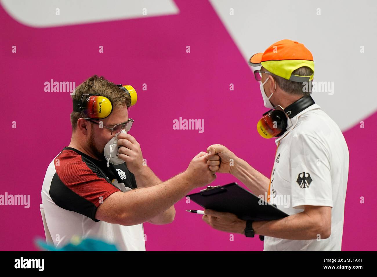 Oliver Geis, left, of Germany, fist bumps his coach after a stage as he ...