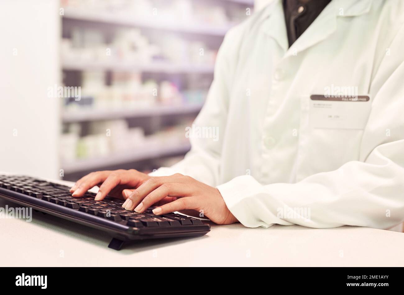 Your information is safe with us. a pharmacist working on a computer in ...