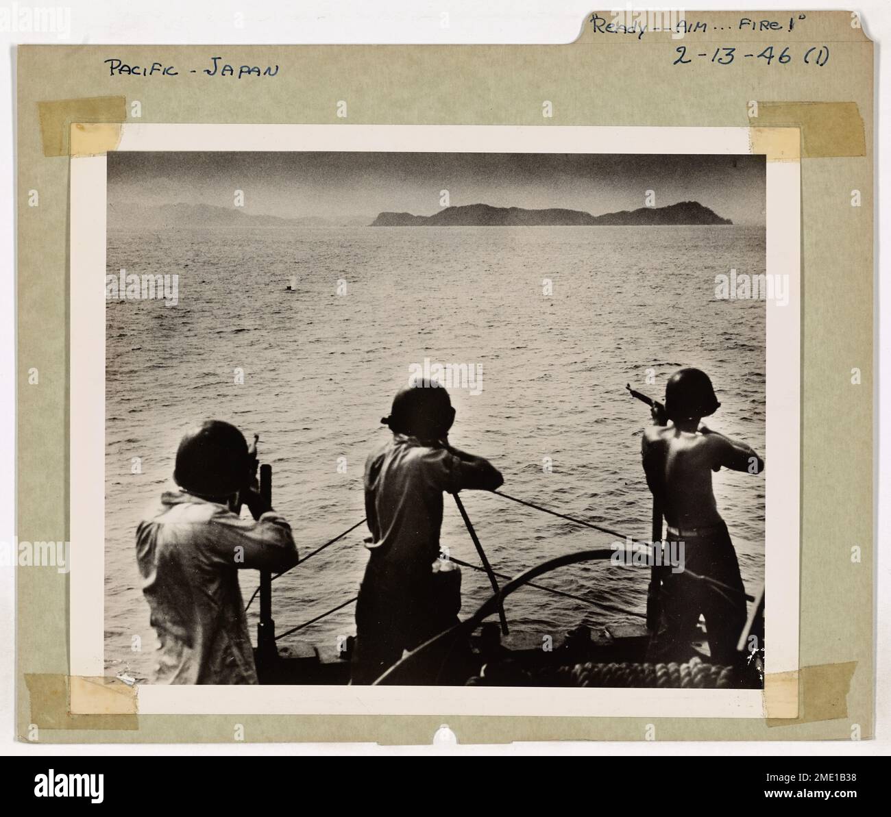 Coast Guardsmen take aim at a floating Japanese mine in the Kii Suido ...