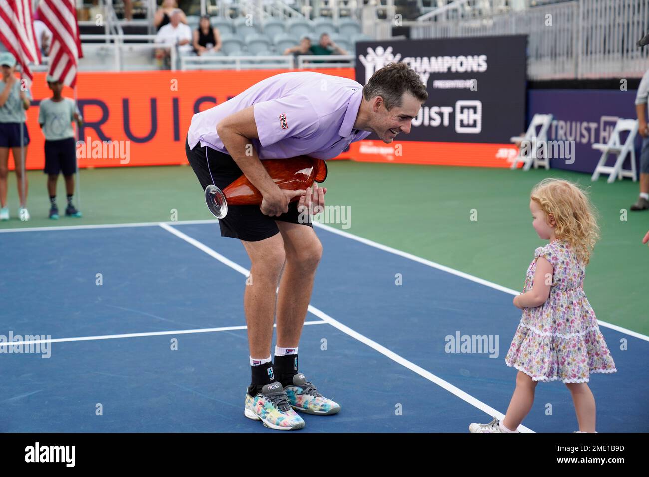 John Isner greets his daughter Hunter Grace Isner, 2, after he won the ...