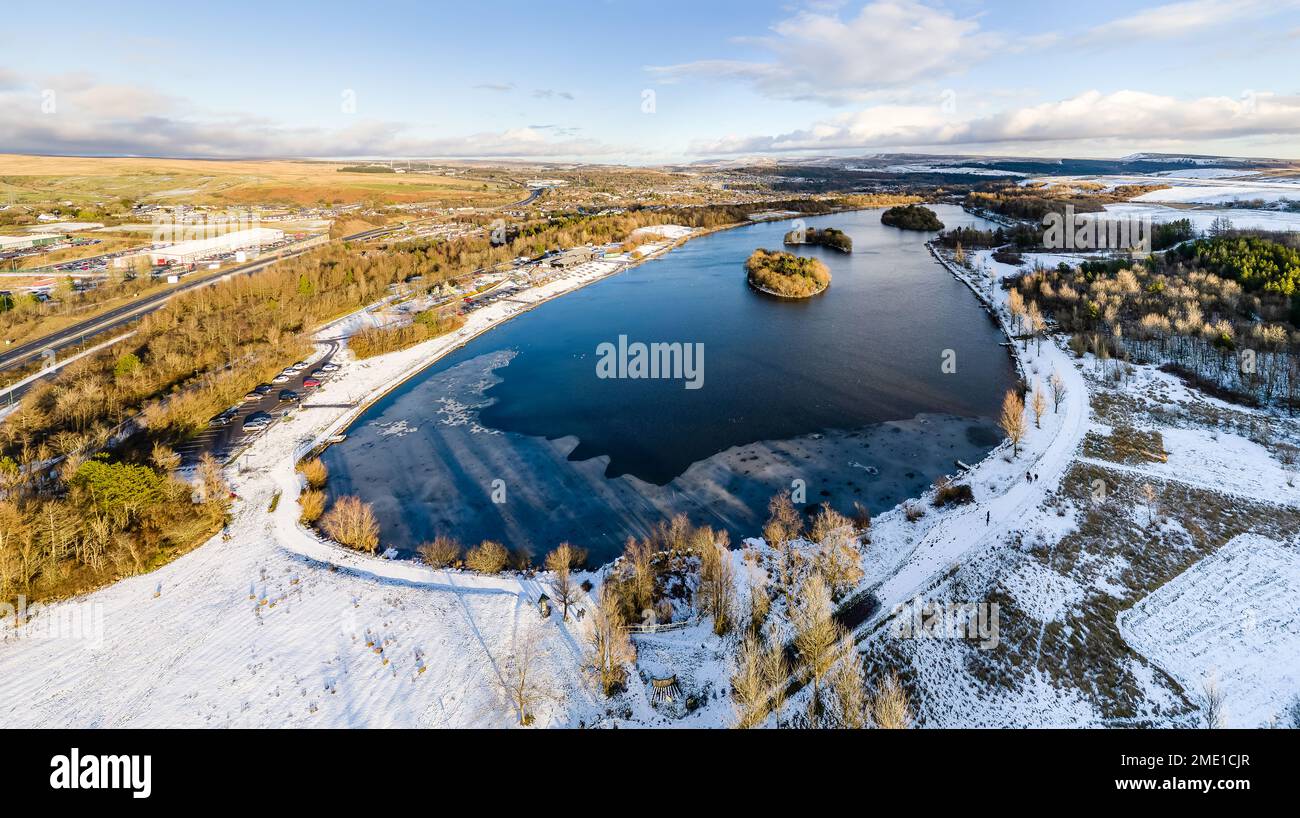 Panoramic aerial view of a freezing lake surrounded by snow Stock Photo ...