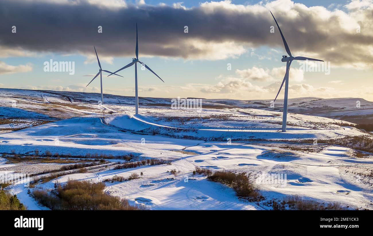Aerial view of wind turbines on a snow covered hillside in Wales (Bryn ...