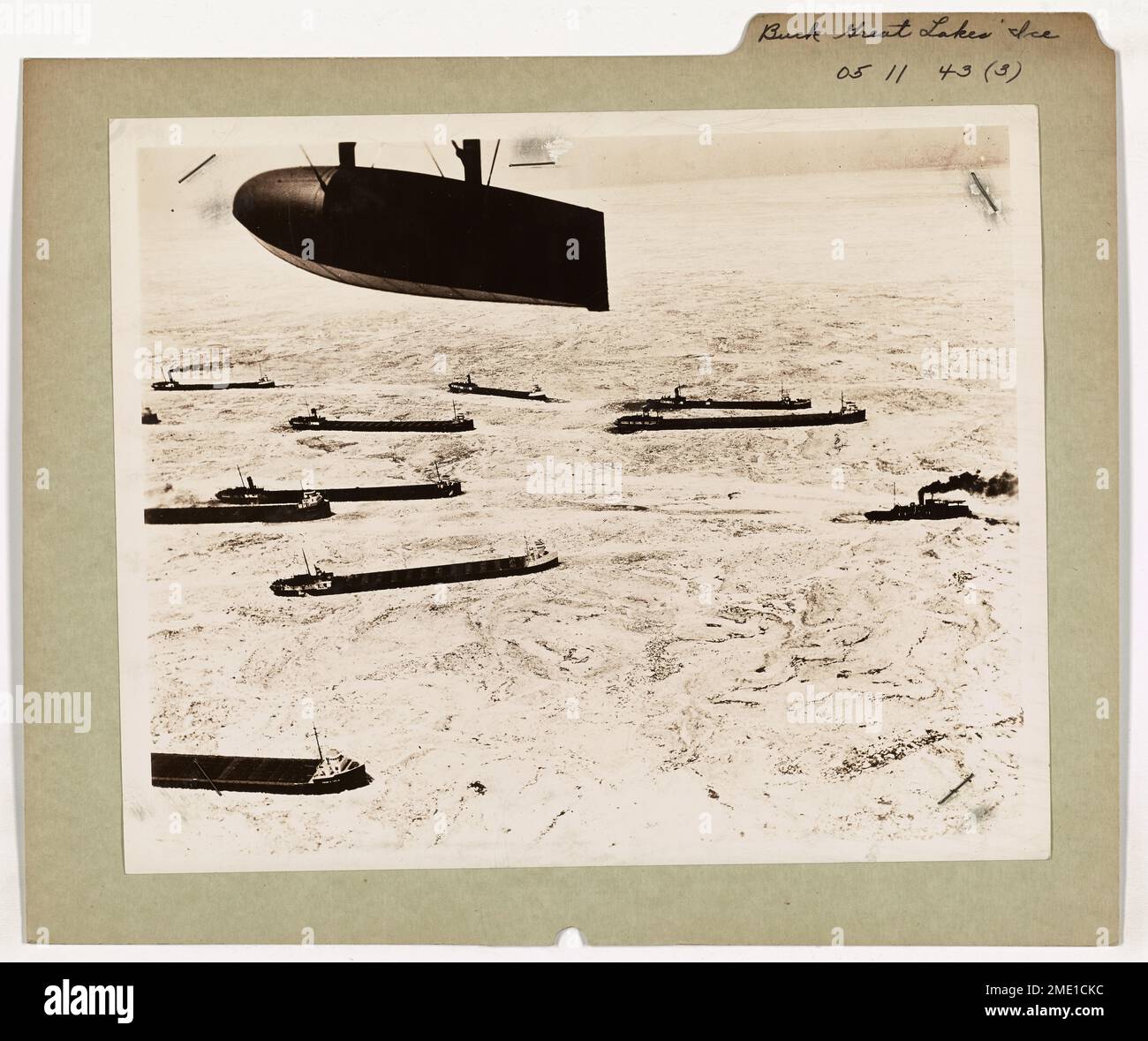 This image shows a tugboat leading ten freighters in an effort to break ...