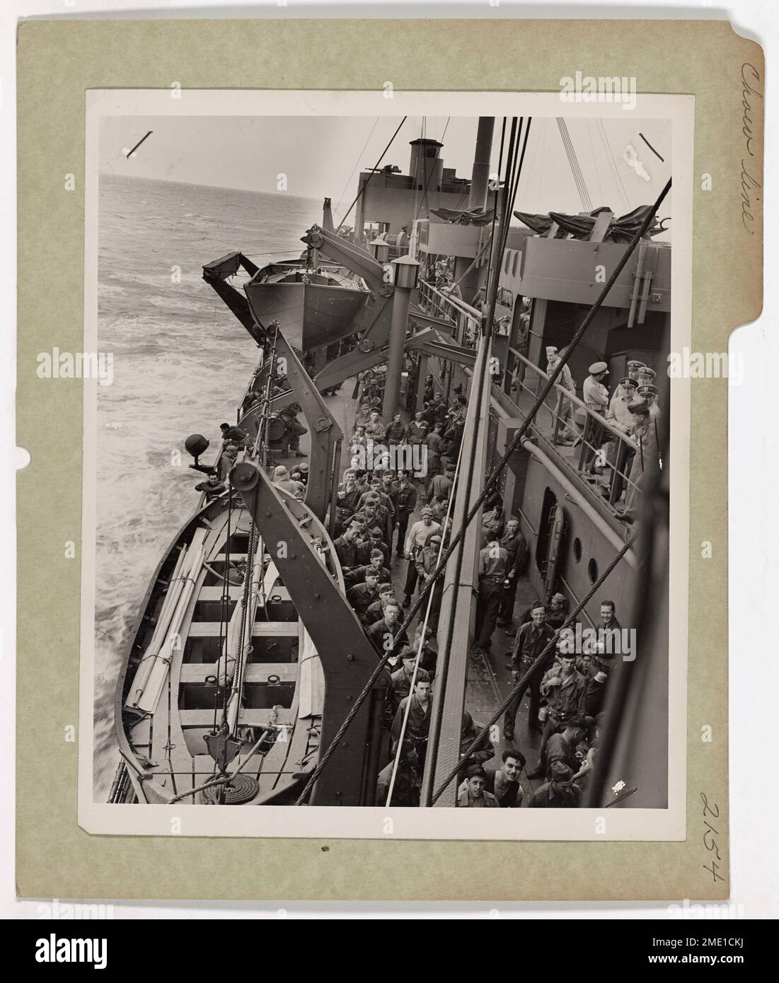 Coast Guardsmen and troops line up for a meal aboard a Coast Guard ...