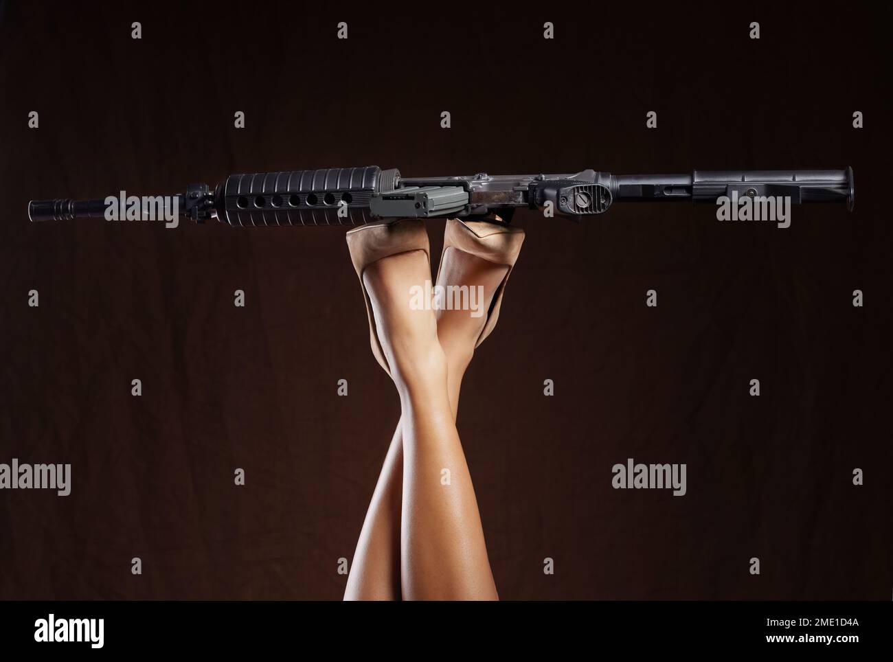 Mafia, criminal and legs of a woman with a gun isolated on a black ...