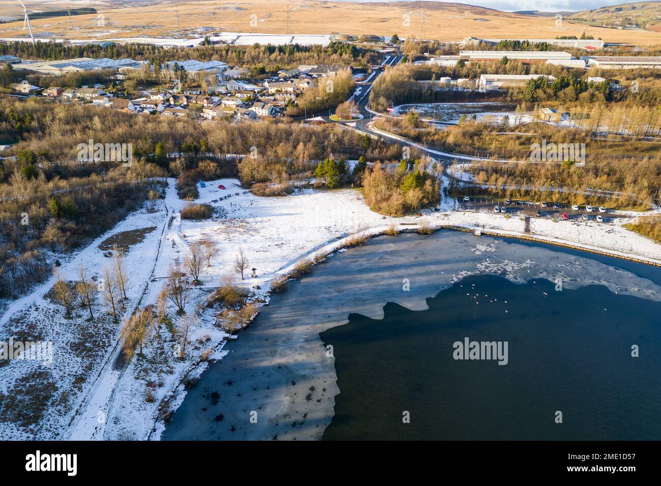 Aerial view of a freezing lake surrounded by snow in the South Wales ...