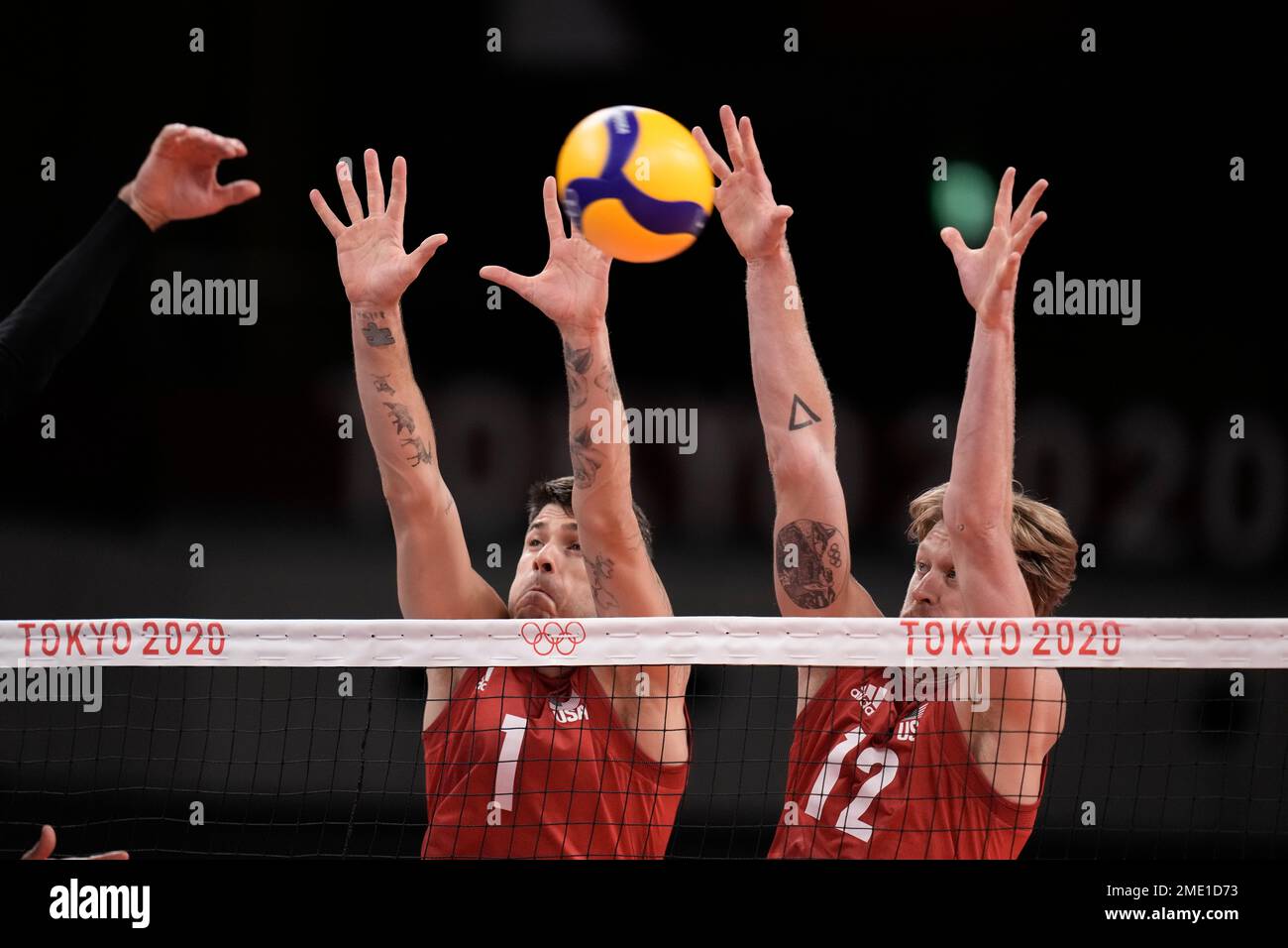 Matthew Anderson and Maxwell Holt, of the United States, try to block a ...
