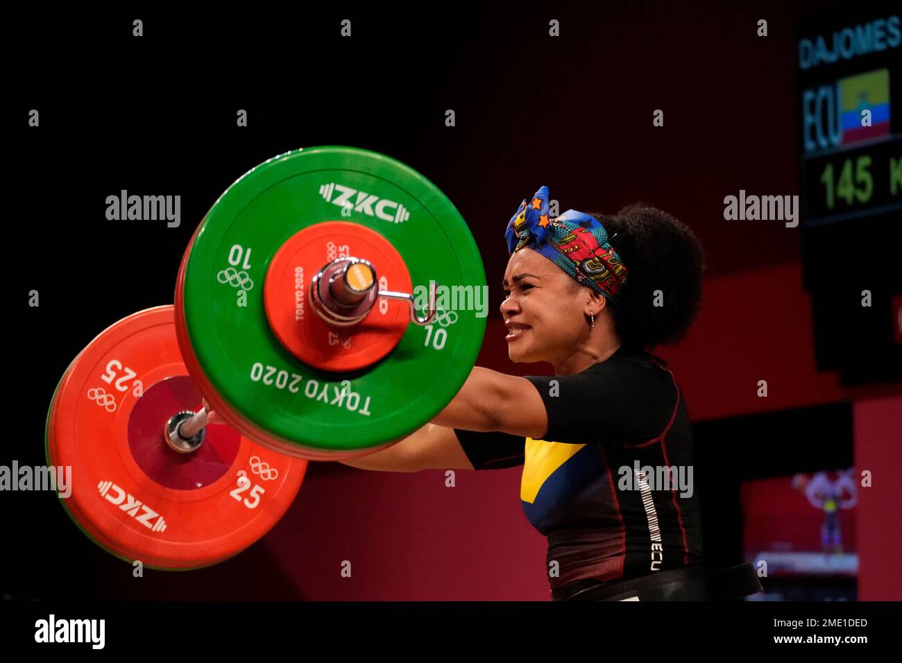 Neisi Patricia Dajomes Barrera of Ecuador lowers the barbell after her ...