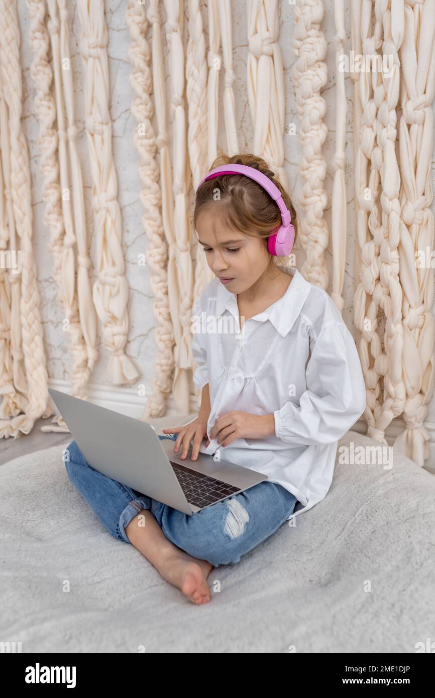 Teenage pupil using laptop notebook preparing for exams at home. Girl ...