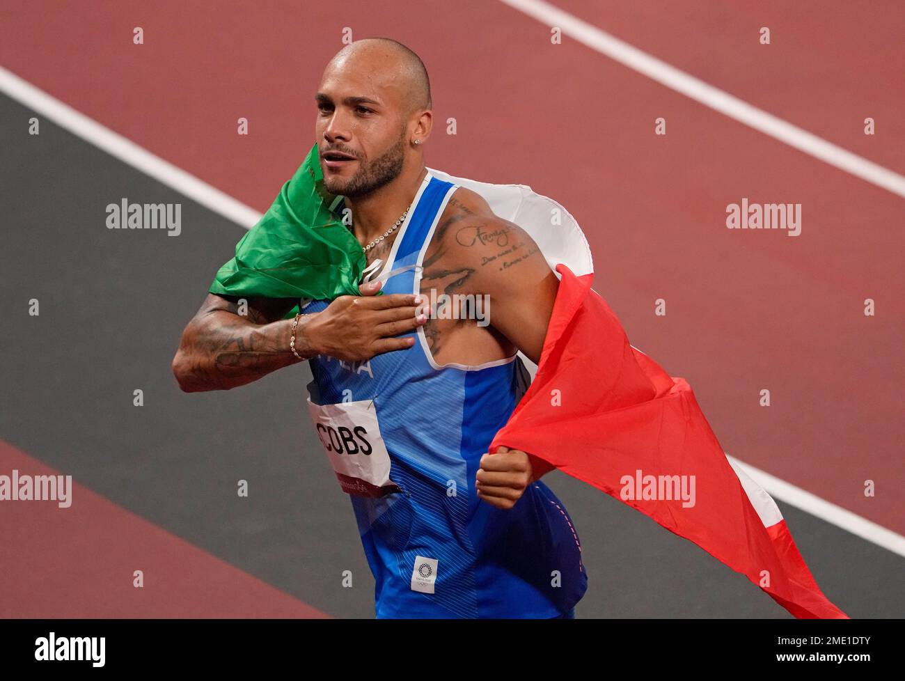 Lamont Marcell Jacobs, of Italy celebrates after winning the gold medal ...