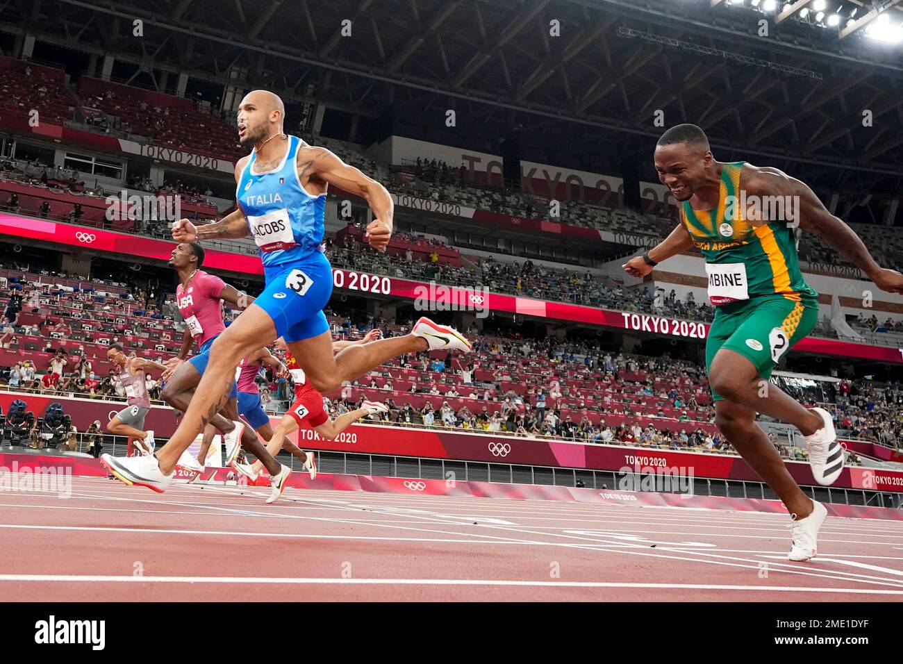 Lamont Jacobs, center, of Italy, celebrates after winning the men's the ...