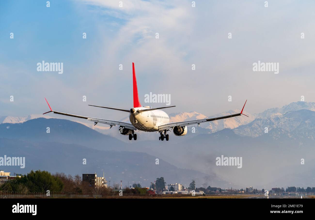 Airplane lands on runway, plane arrives at airport Stock Photo - Alamy