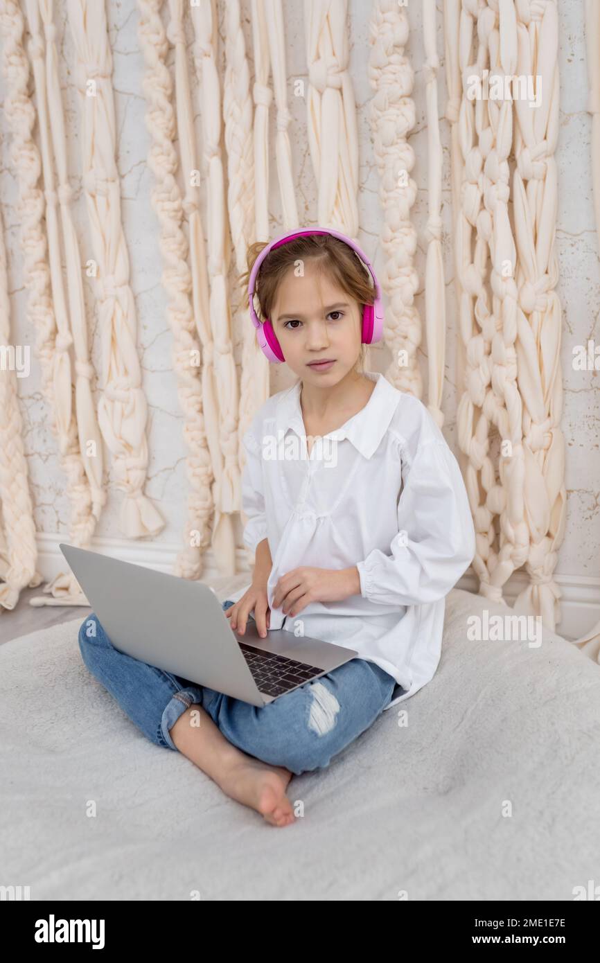 Teenage pupil using laptop notebook preparing for exams at home. Girl ...