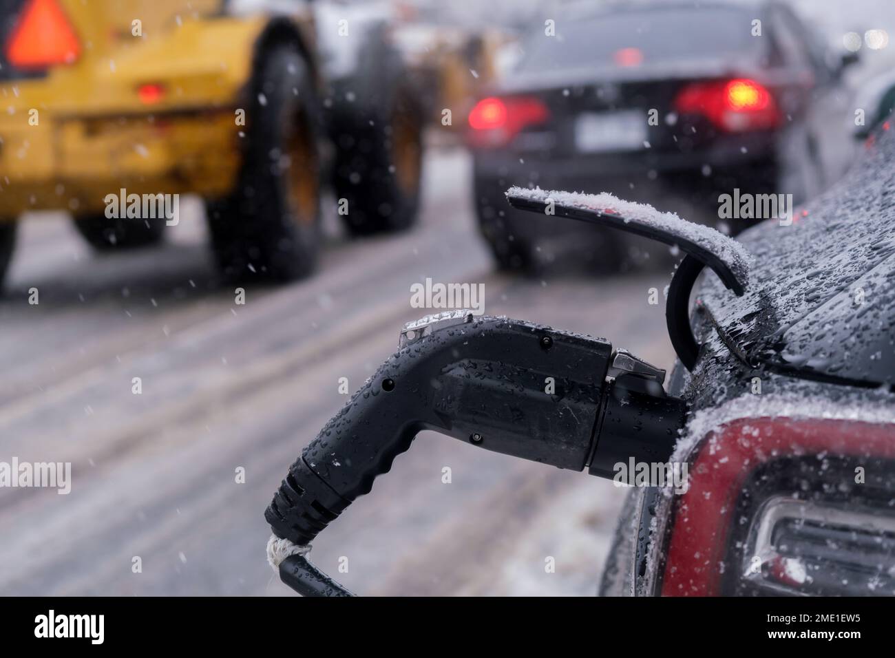 Electric car getting charged in Montreal during snowstorm Stock Photo ...