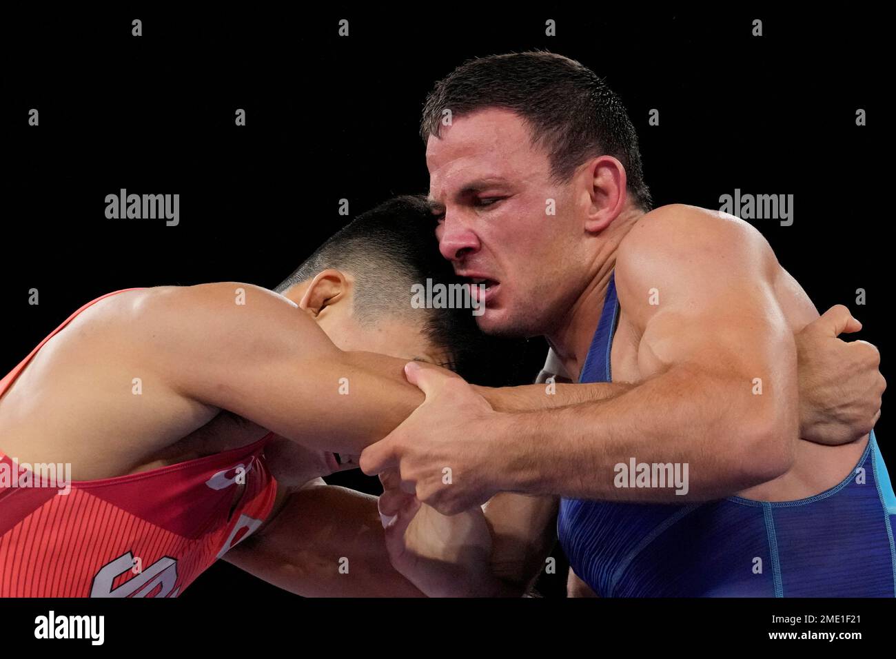 Ukraine's Lenur Temirov, right, competes against Japan's Kenichiro ...