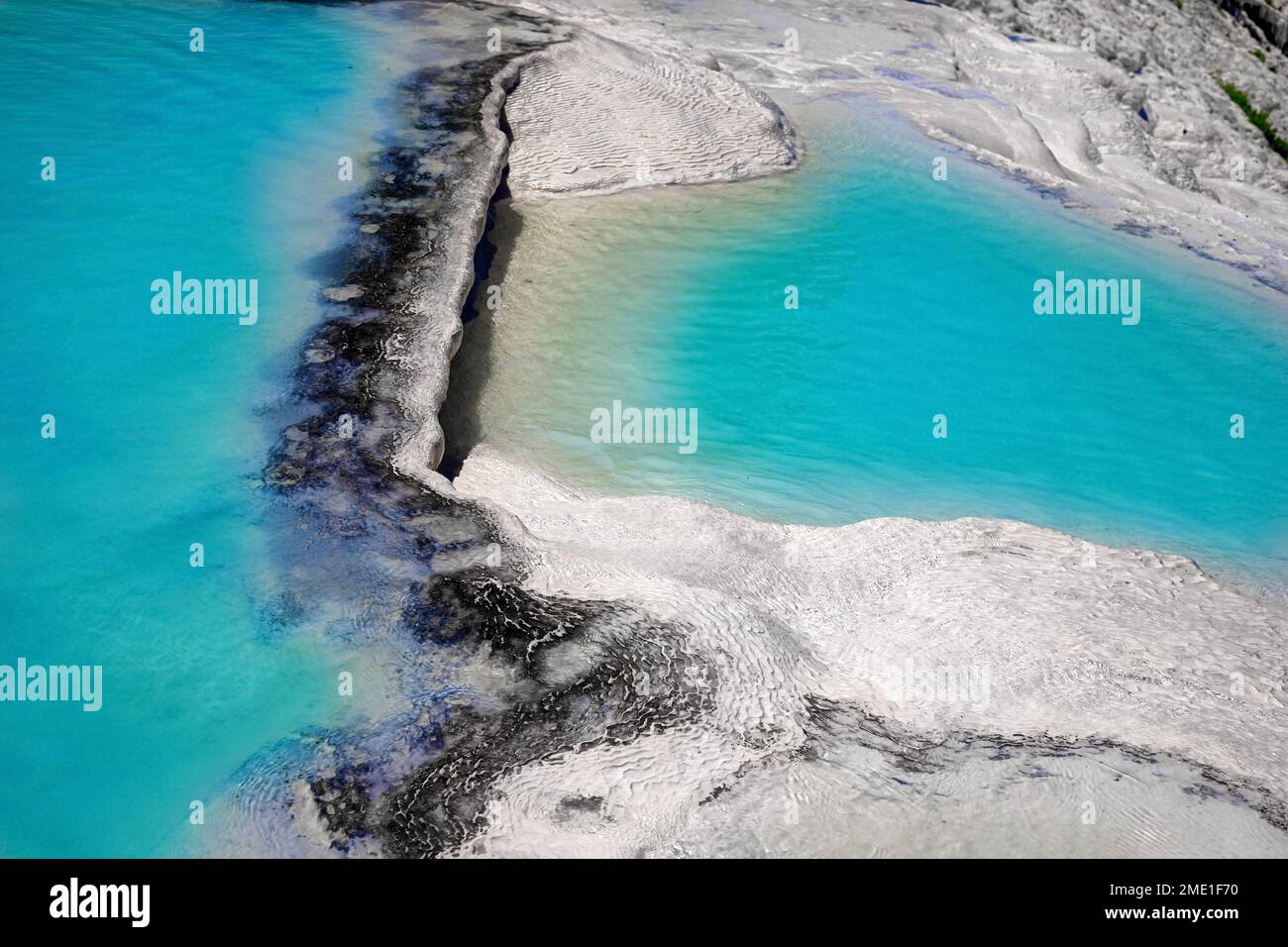 View of natural terraces in Pamukkale on a summer day. Close-up texture ...