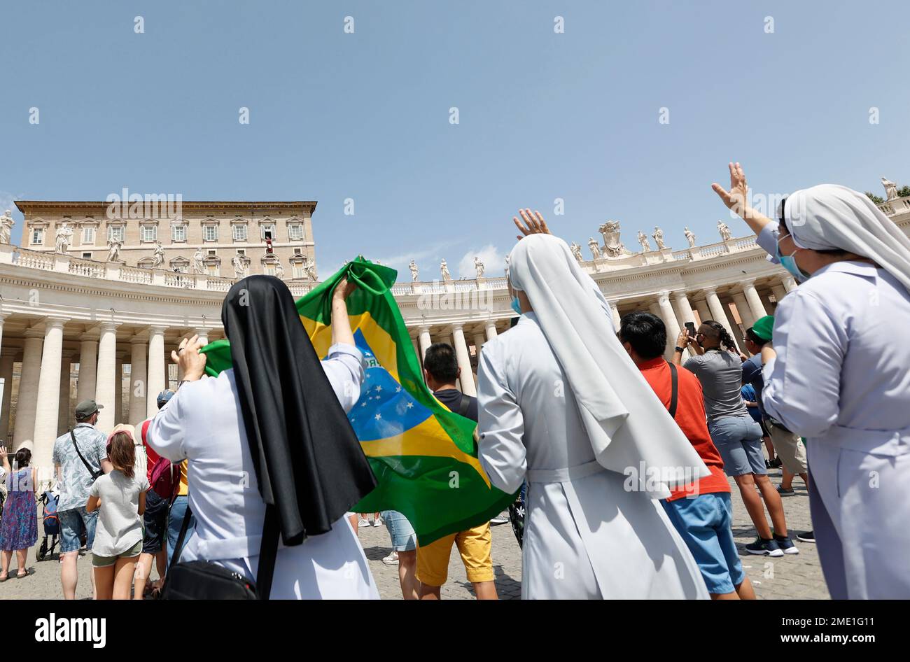 Nuns wave to Pope Francis as he delivers the Angelus prayer from his ...