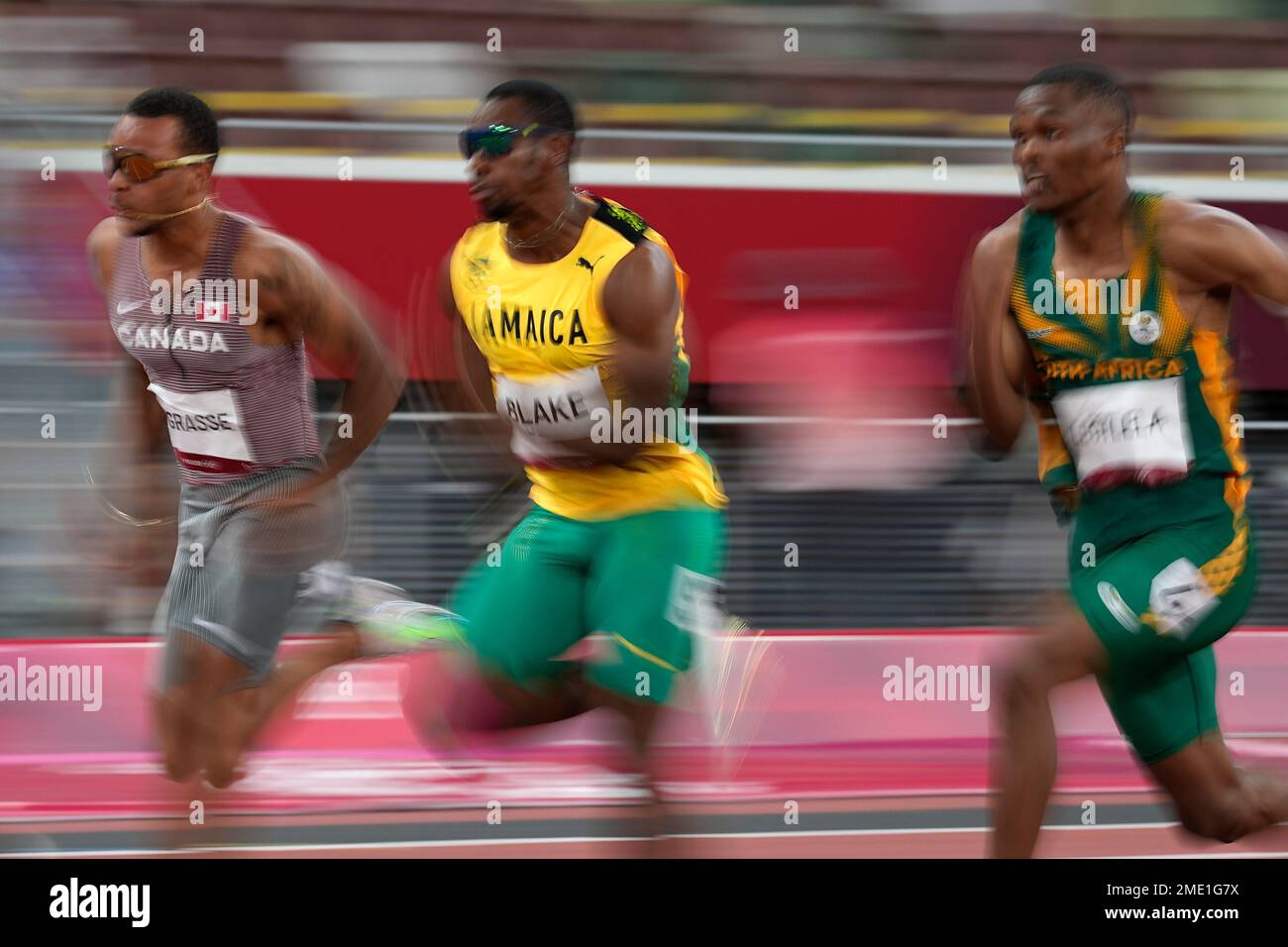 Yohan Blake, centre, of Jamaica, runs in a semifinal of the men's 100 ...
