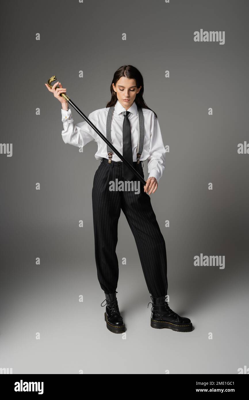 full length of stylish woman in elegant oversize outfit and laced-up ...