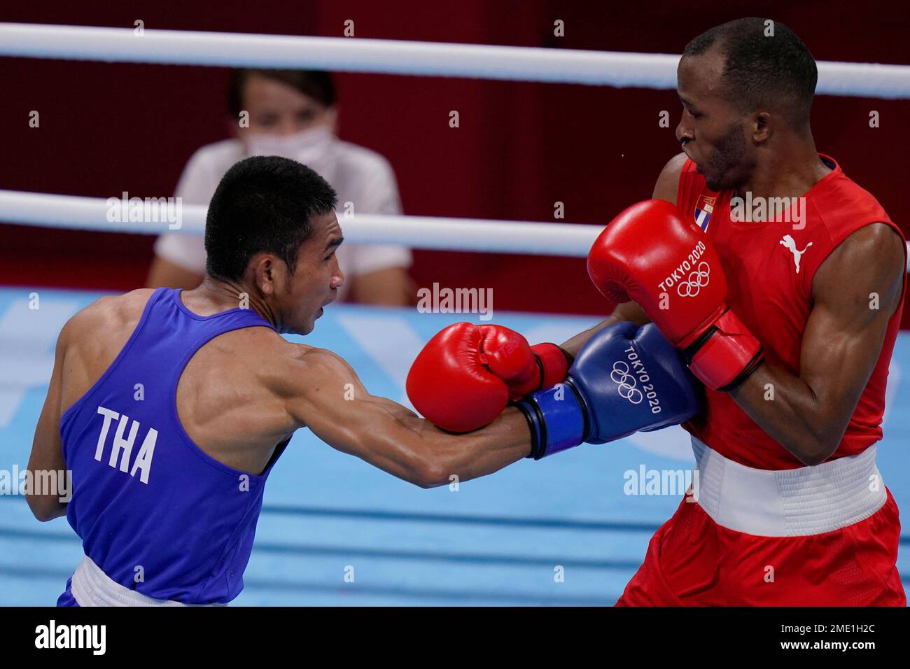 Cuba's Lazaro Alvarez, right, exchanges punches with Thailand's ...